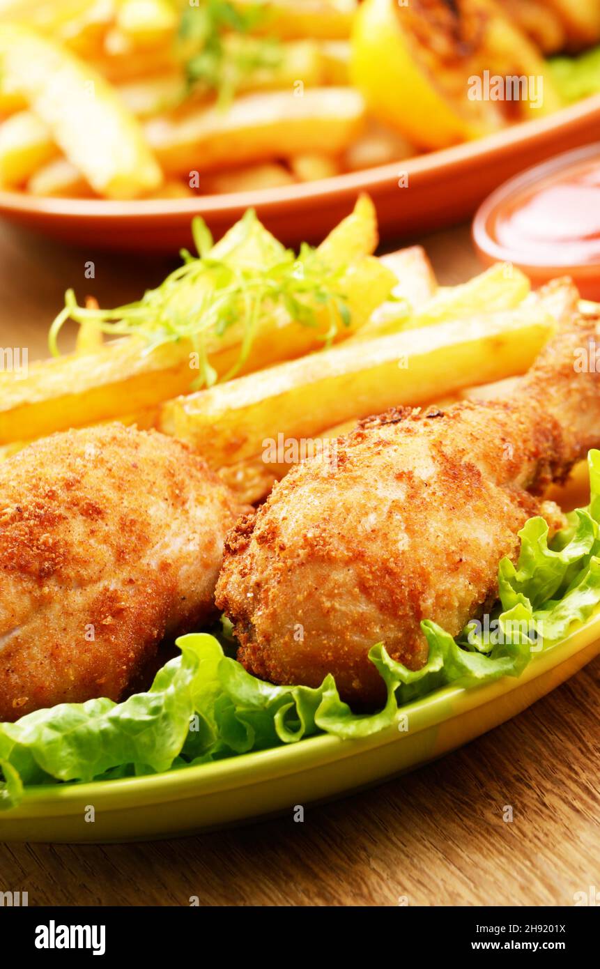 Fried chicken with french fries on the table Stock Photo - Alamy