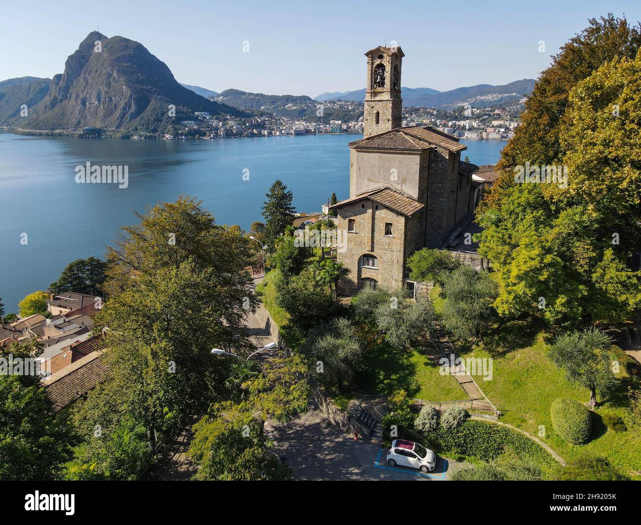 Drone view at St. George church and the bay of Lugano in the italian ...