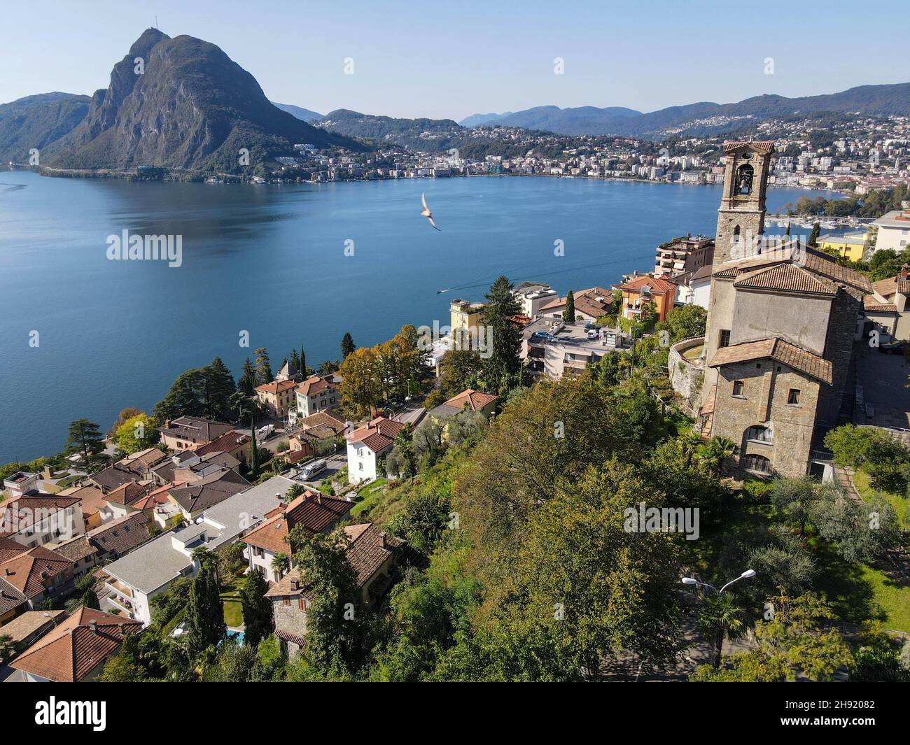 Drone view at St. George church and the bay of Lugano in the italian ...