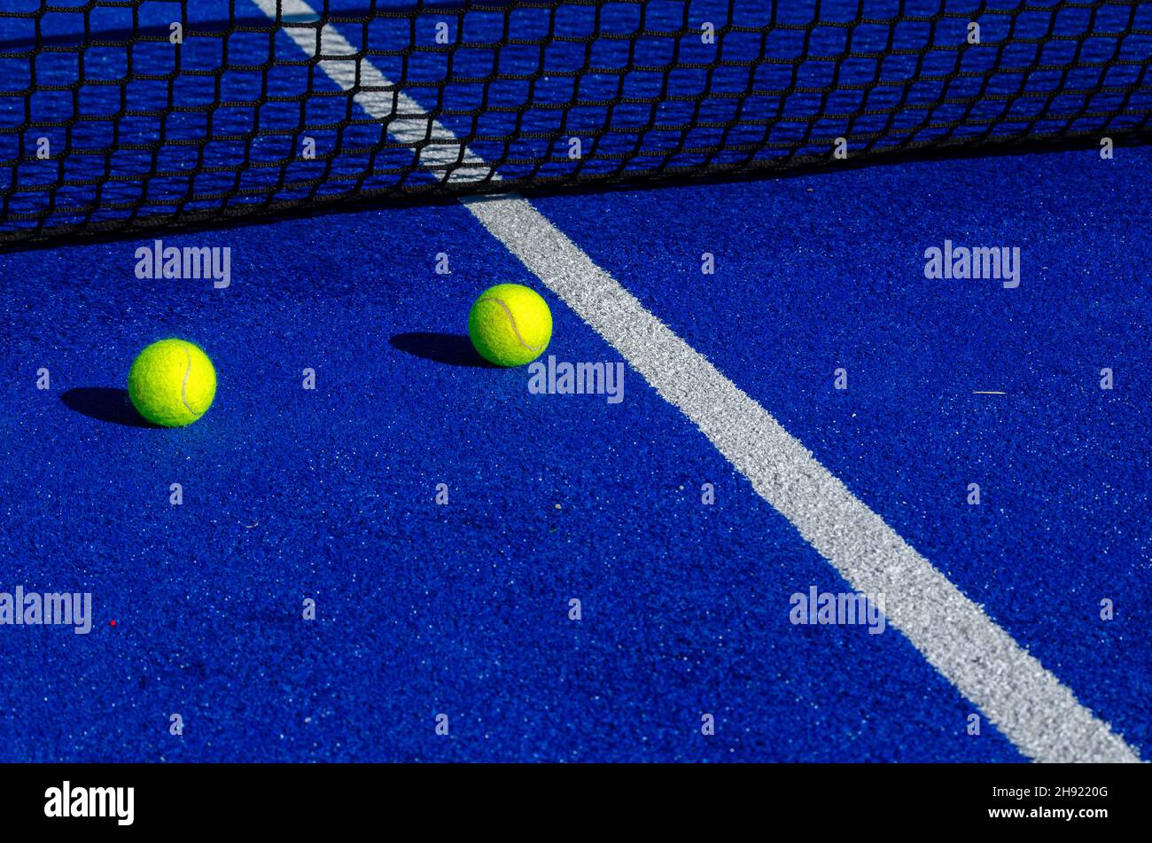 Two balls next to the net of a paddle tennis court Stock Photo - Alamy