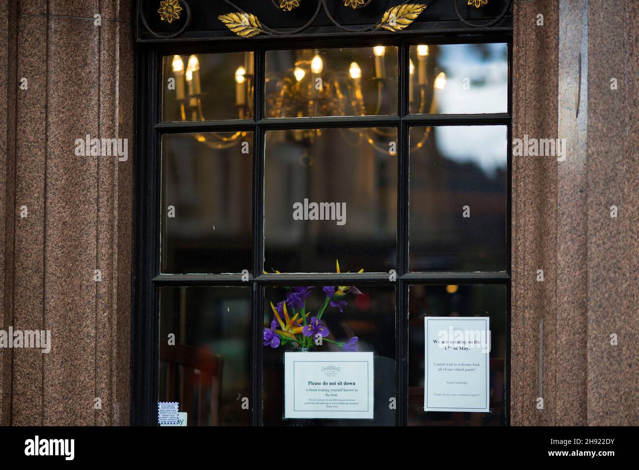 Flowers and notices that inform customers of the reopening date and of ...