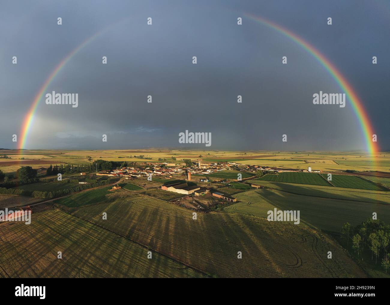 Drone shot of a rural town with a rainbow Stock Photo - Alamy