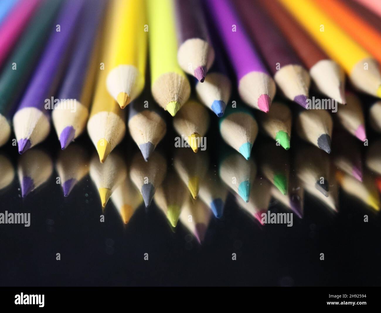 Group of colored pencils on a reflective surface Stock Photo - Alamy