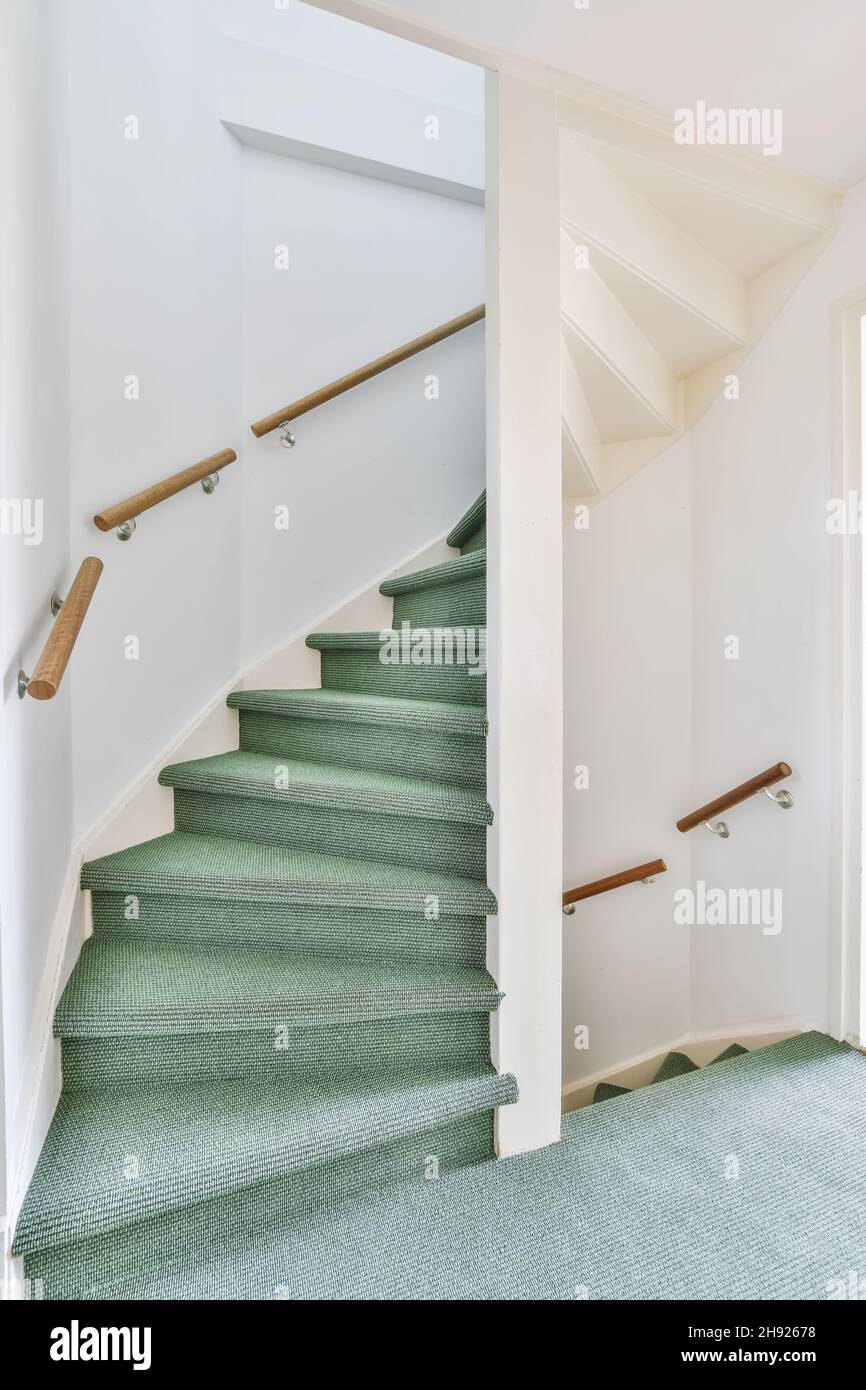Gorgeous staircase with a gentle green floor Stock Photo - Alamy
