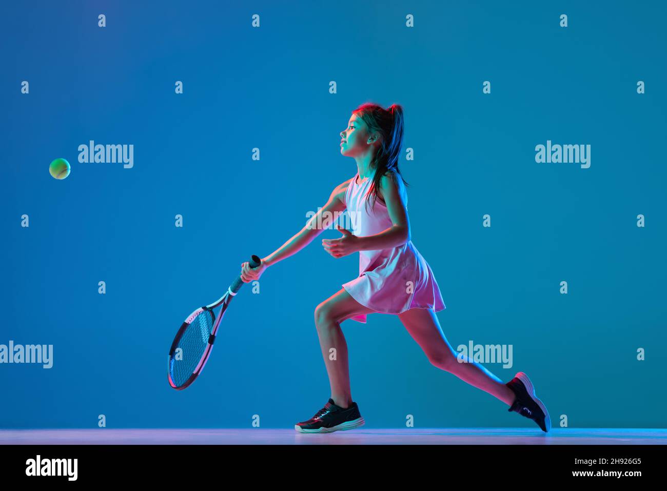 Portrait of little girl, beginner tennis player playing tennis isolated ... Portrait of little girl, beginner tennis player playing tennis isolated ...