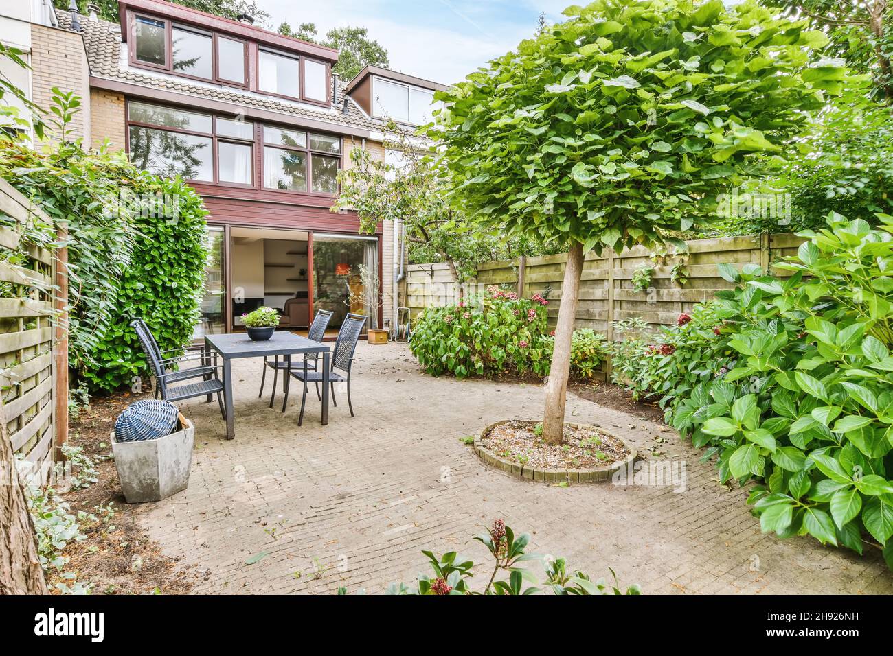 Attractive courtyard of the house with lots of greenery Stock Photo - Alamy