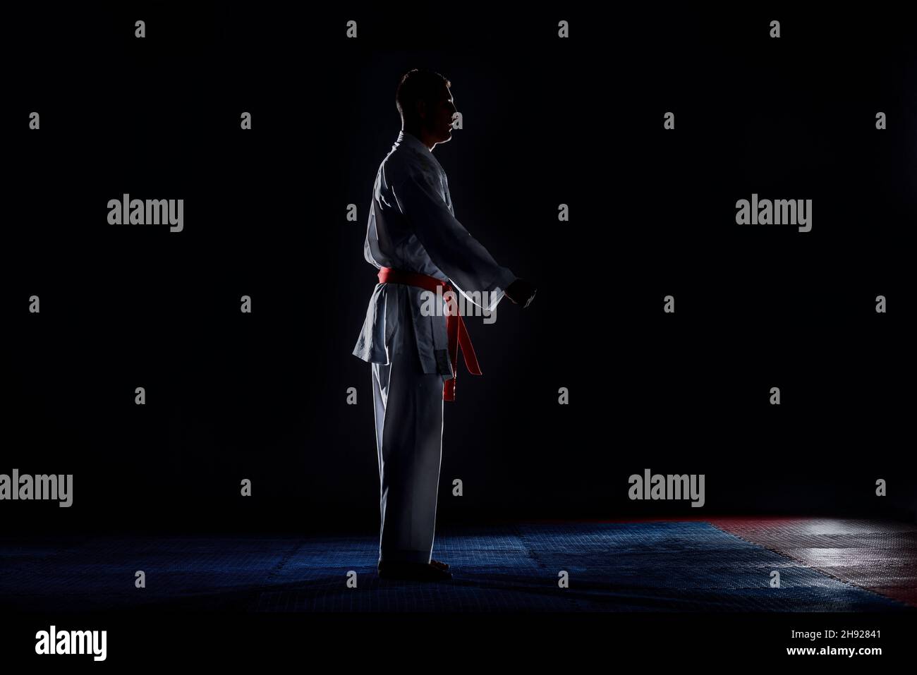 A young strong man in a white kimono for sambo, jiu jitsu and other ...