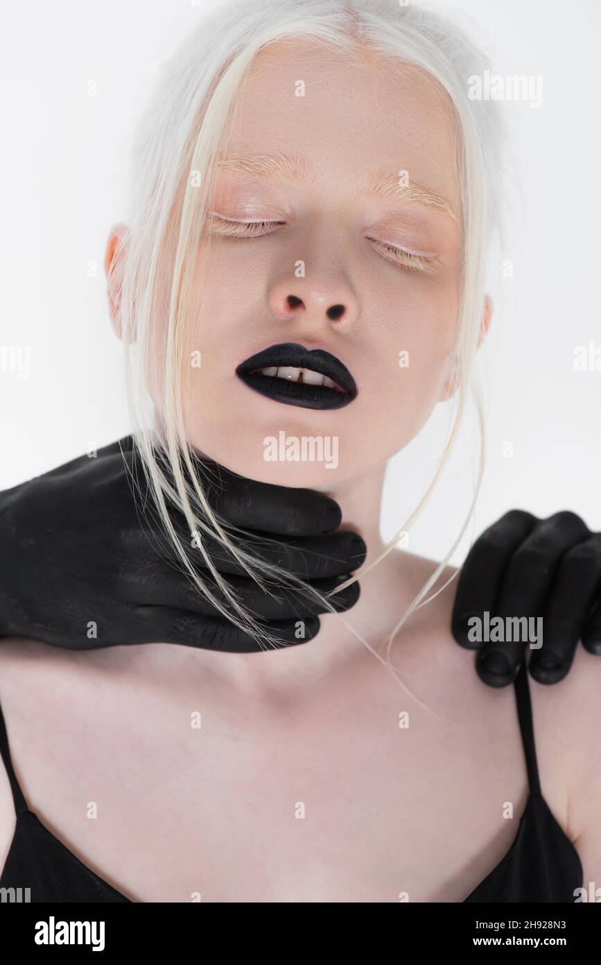 Male hands in black paint touching albino woman isolated on white Stock ...