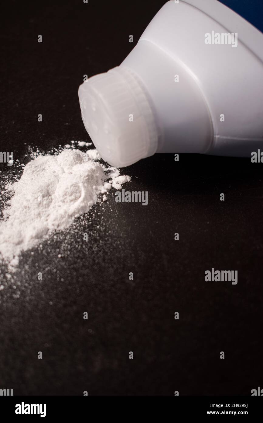 Talcum powder and white bottle fallen on a black background Stock Photo ...