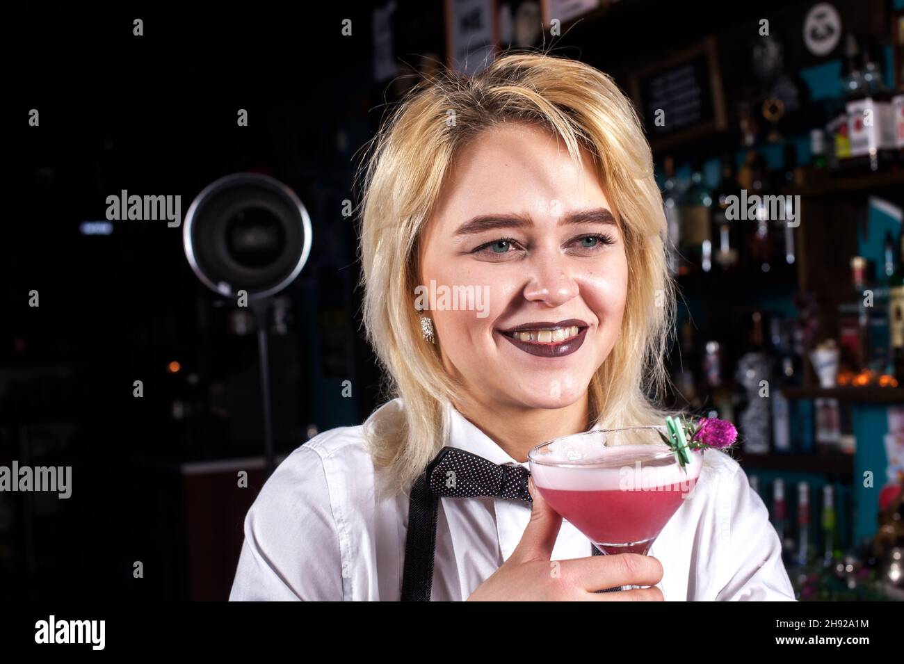 Confident woman bartending is pouring a drink in the bar Stock Photo ...