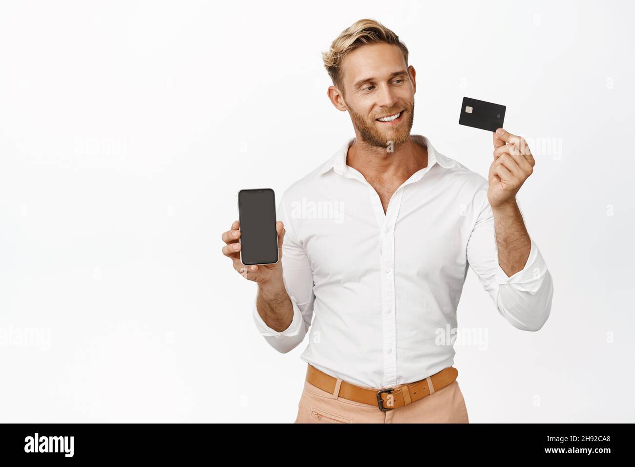 Smiling male entrepreneur showing credit card with proud, satisfied ...