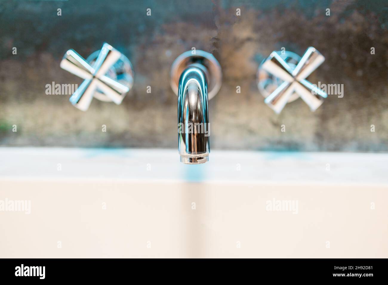 Close up chrome metal silver tap with white ceramic bath in luxury ...