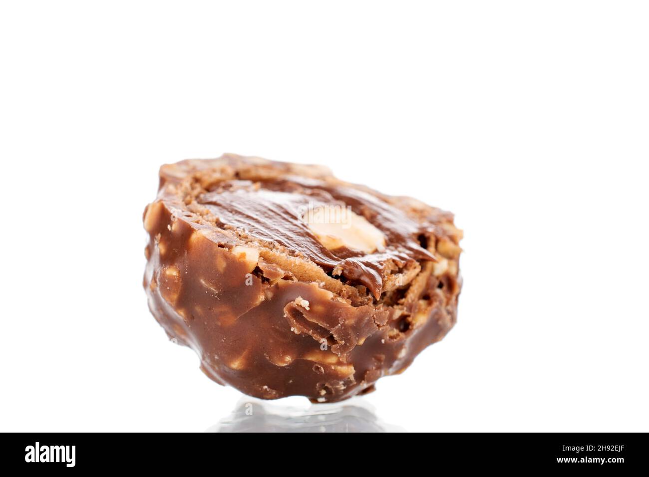 One half of chocolate candy with nuts, close-up, isolated on white ...