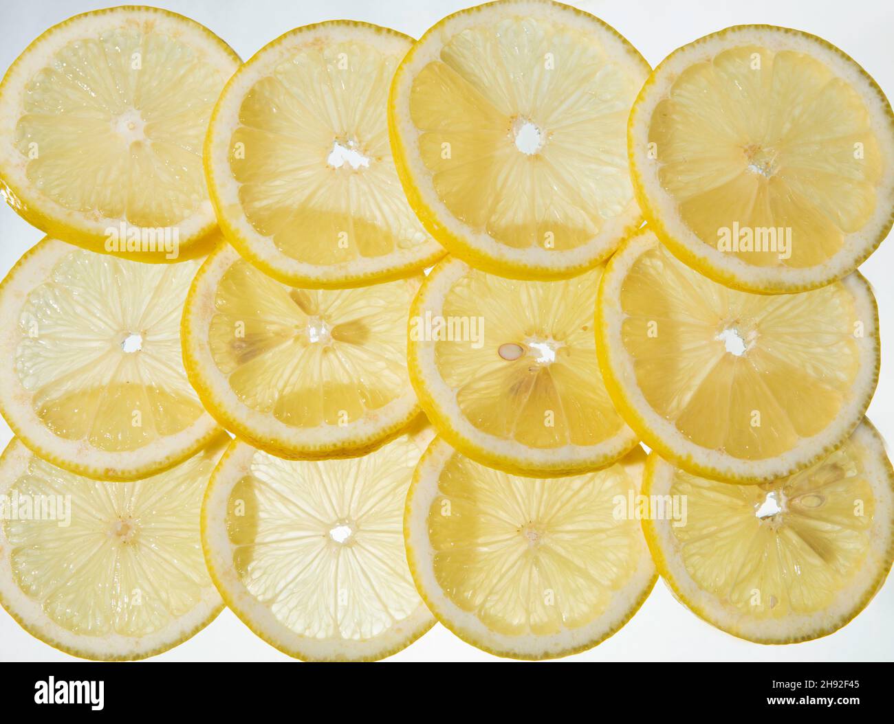 Slices of lemon in an arranged pattern with back lighting Stock Photo ...