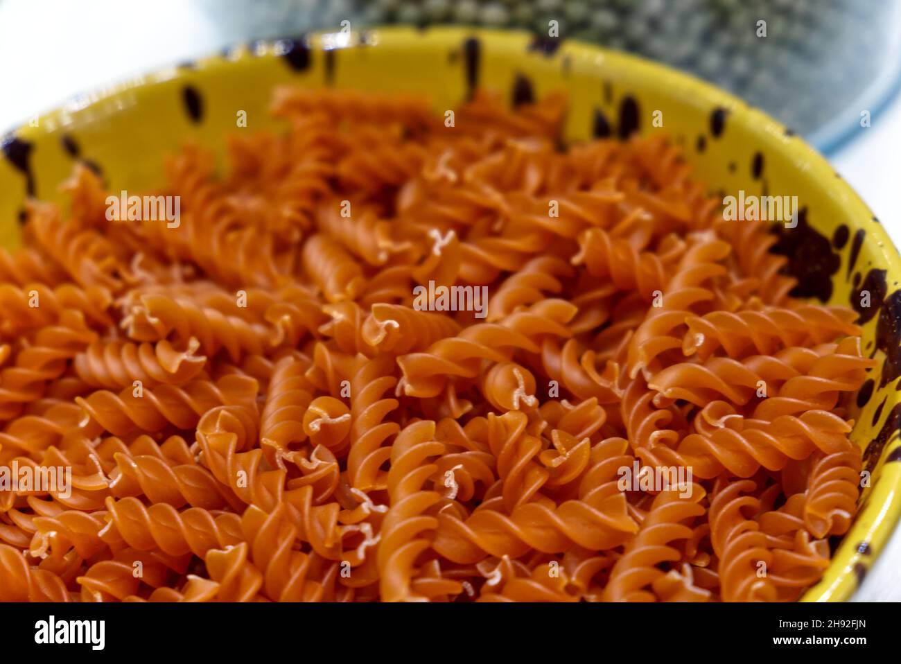 a bowl of fusilli flavored with pepper ready to cook Stock Photo - Alamy