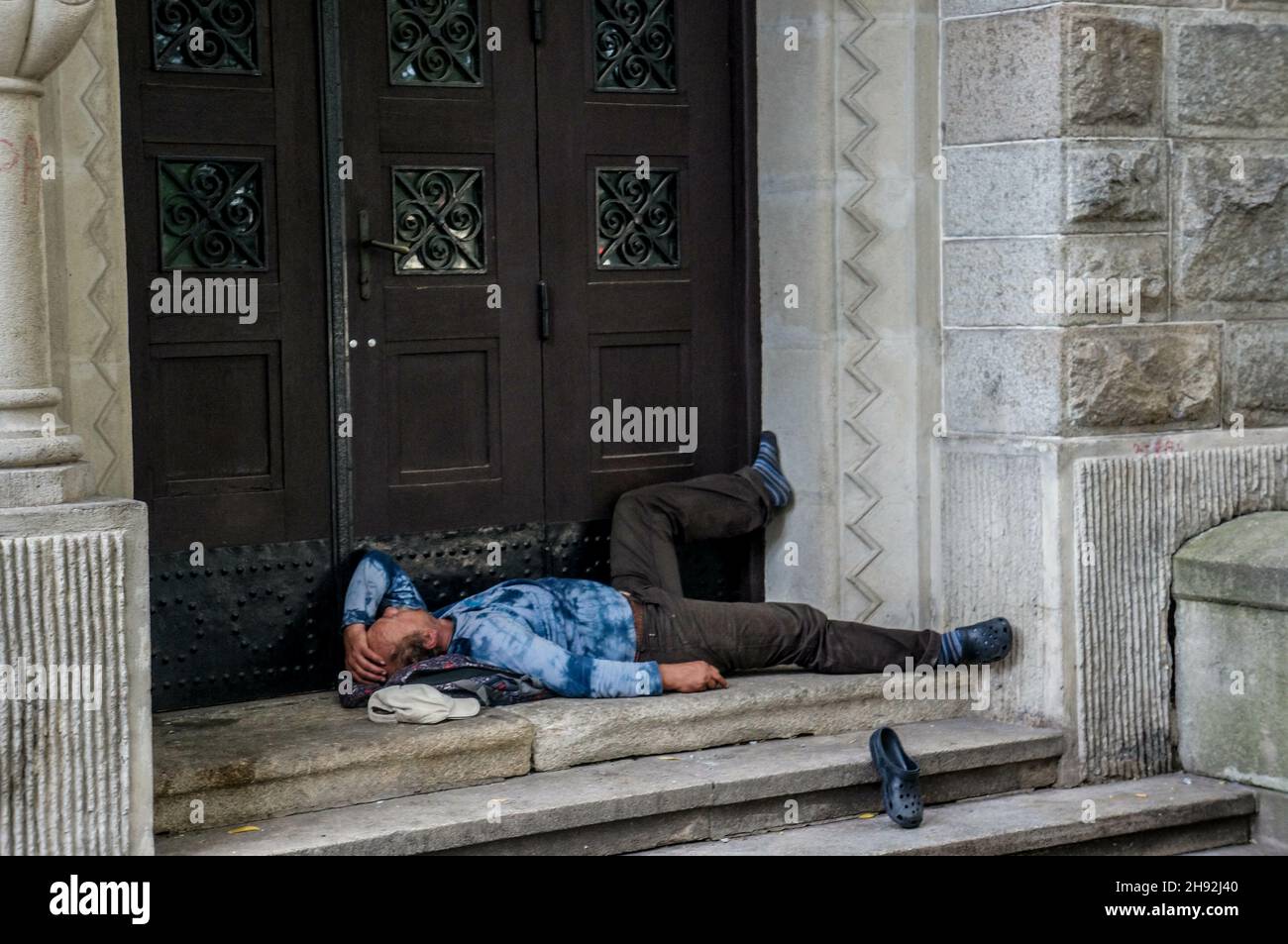 BRATISLA, SLOVAKIA - Aug 01, 2014: A homeless person sleeping outside ...