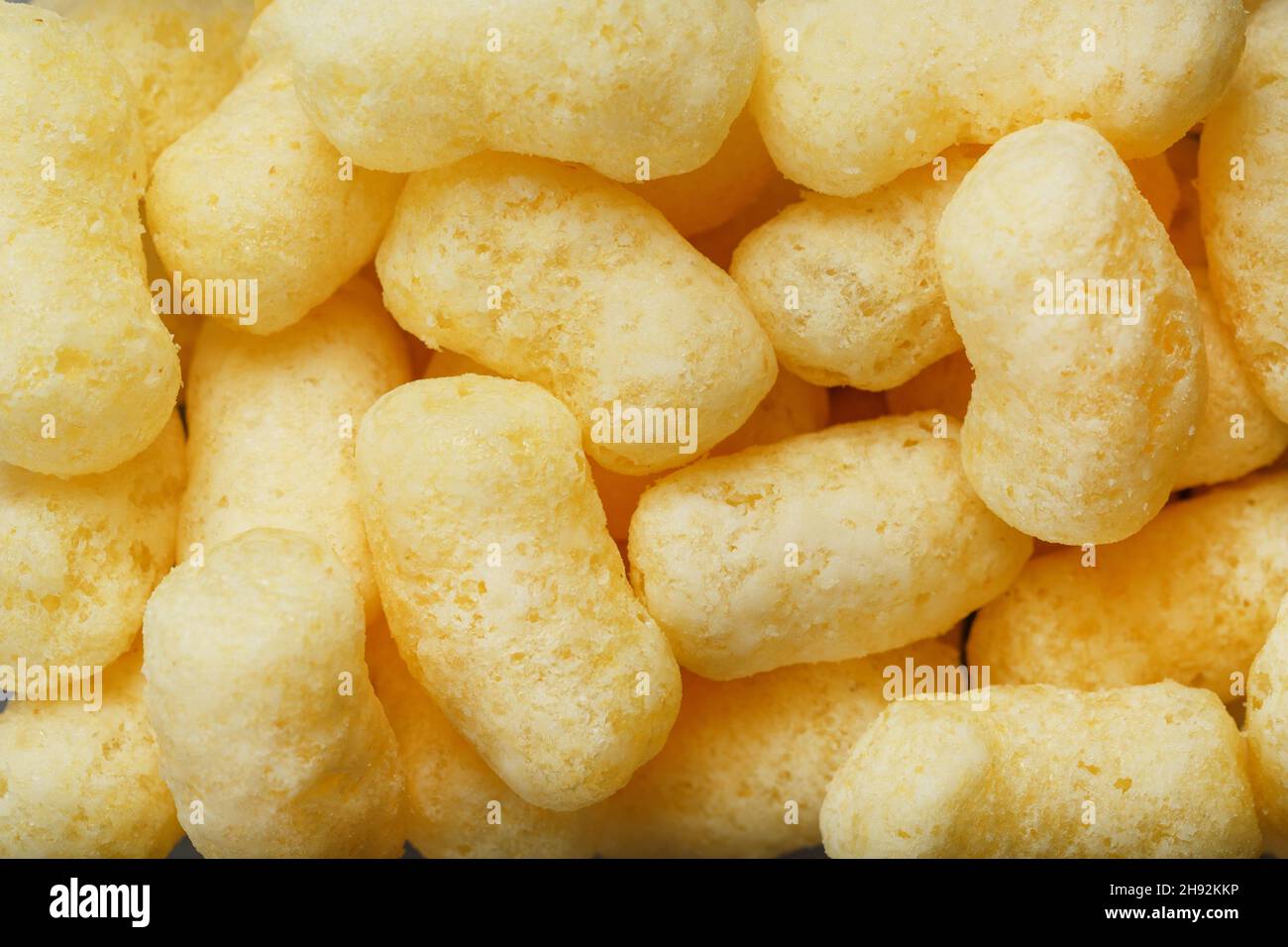 Corn sticks in powdered sugar as a texture. View from above Stock Photo ...