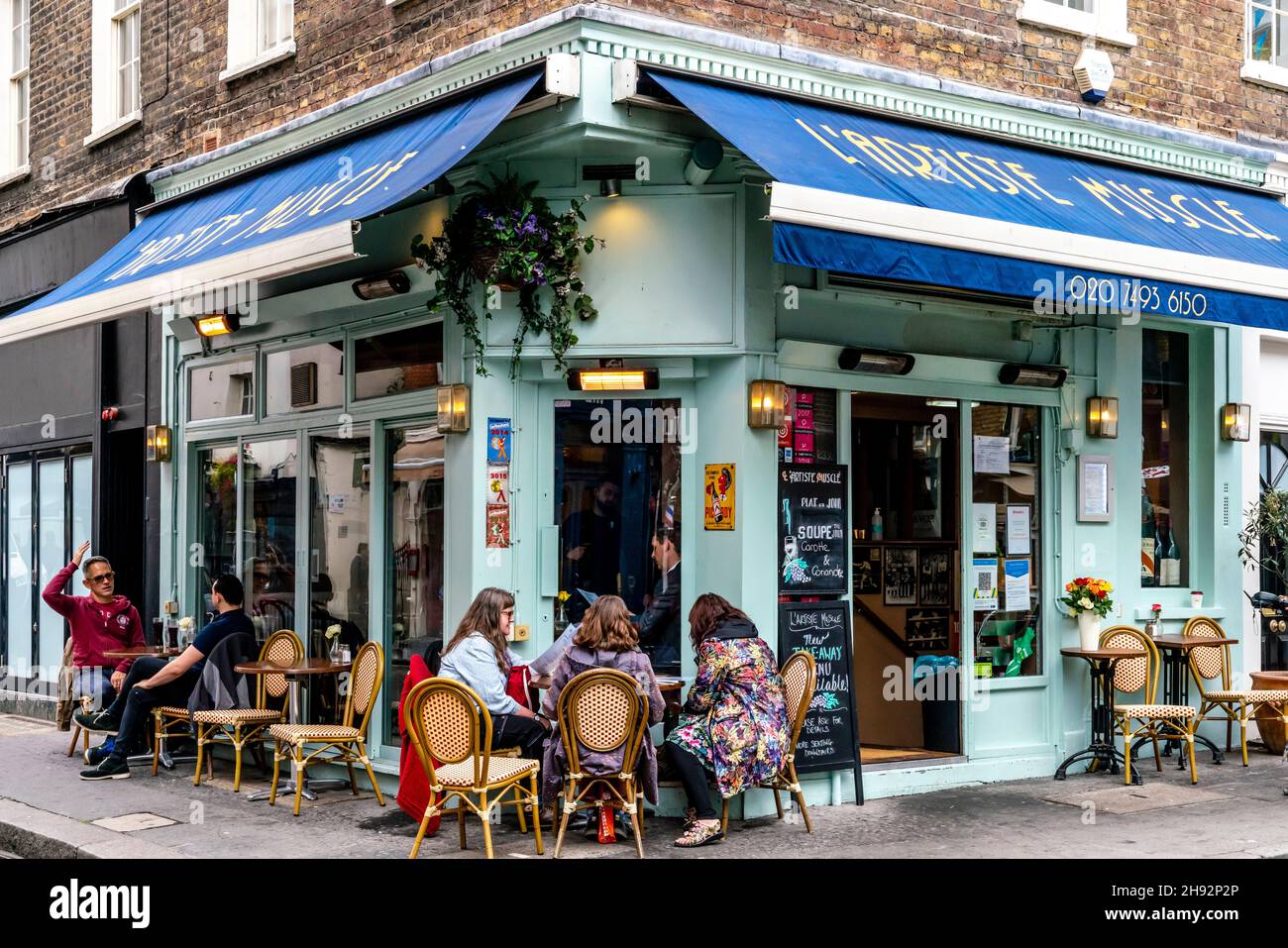 People Sitting Outside The L’Artiste Muscle Restaurant Having Lunch ...