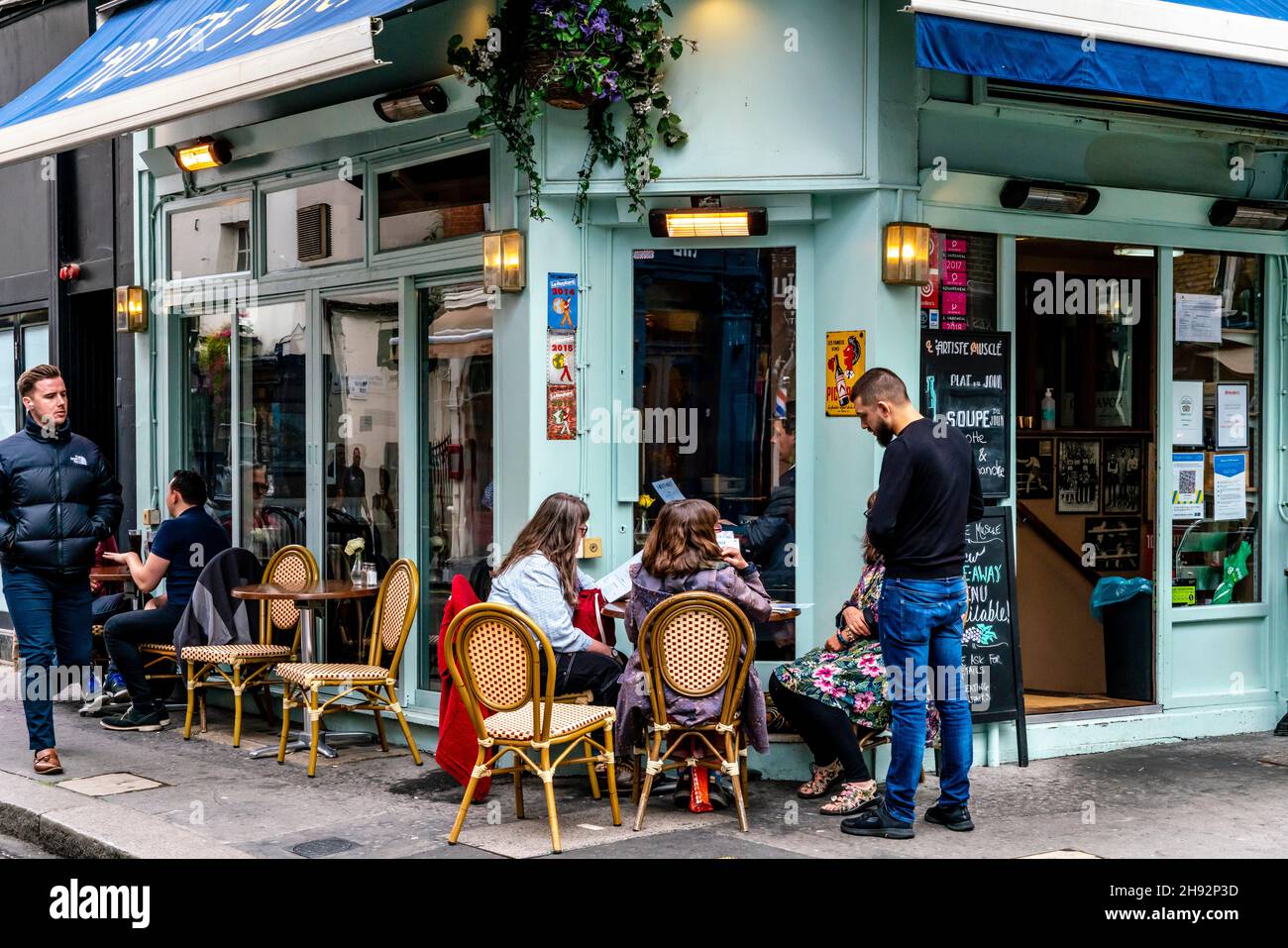 People Sitting Outside The L’Artiste Muscle Restaurant Having Lunch ...
