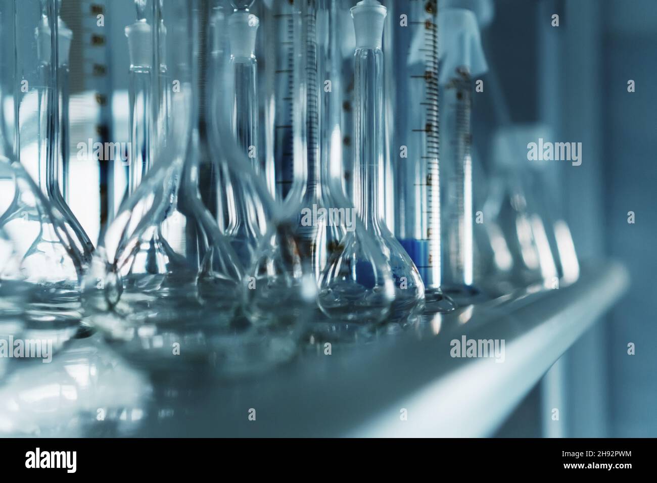 Laboratory glass flasks and test tubes on a rack. Research concept ...