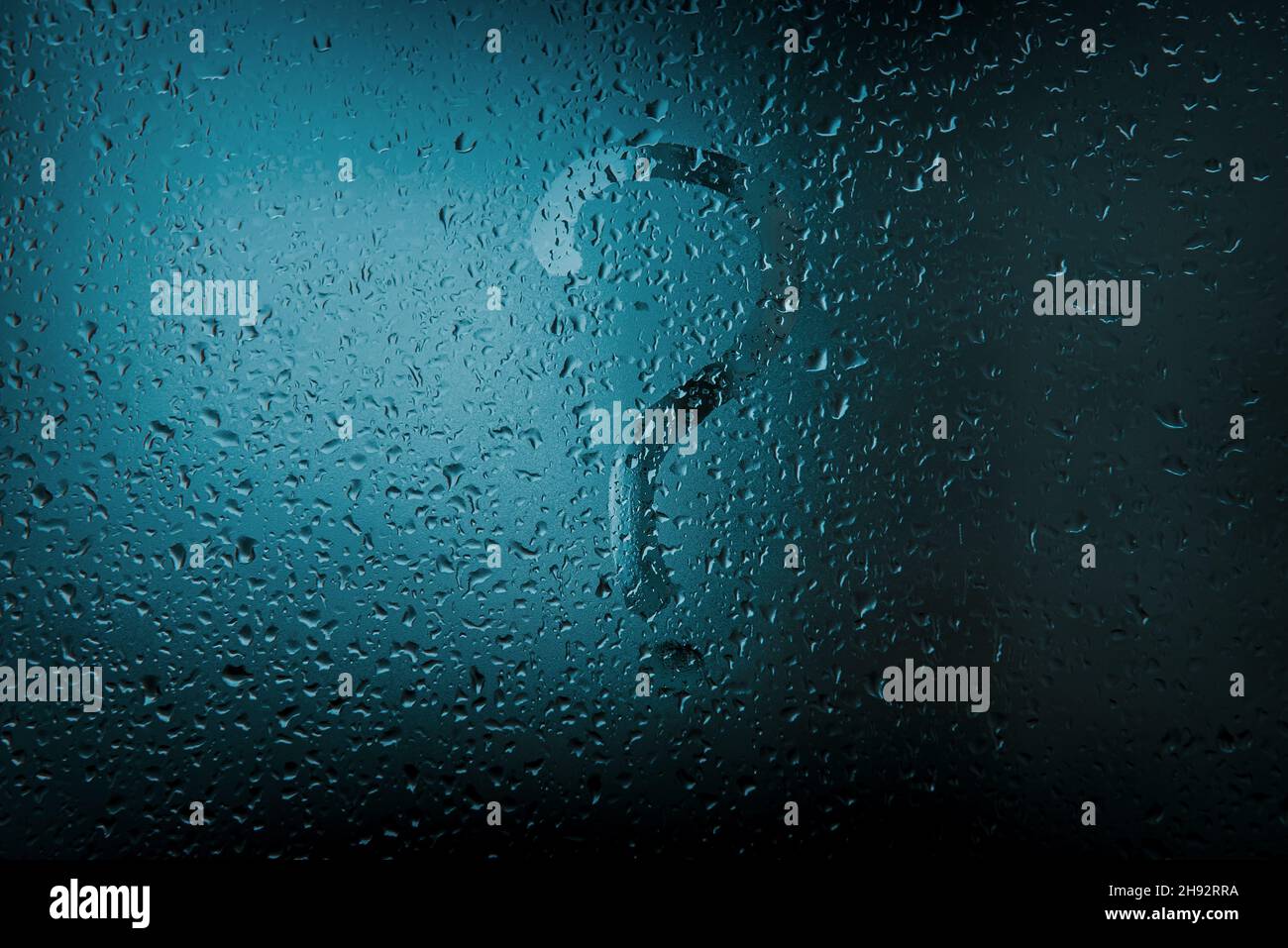 A question mark on rain-wet glass. Water drops on the window. Question ...