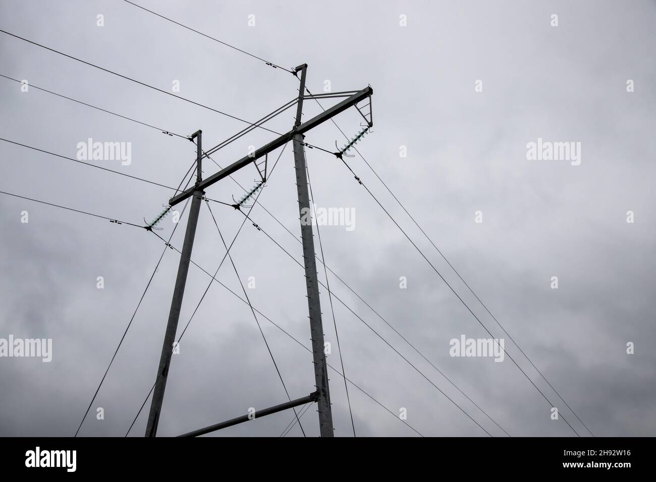 Low angle of a power pole with dark cloudy sky on the background Stock ...