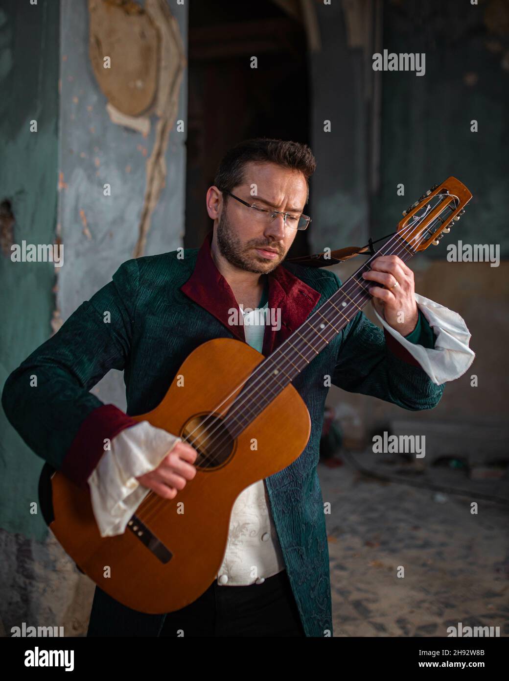 Serbian man in glasses playing guitar Stock Photo - Alamy