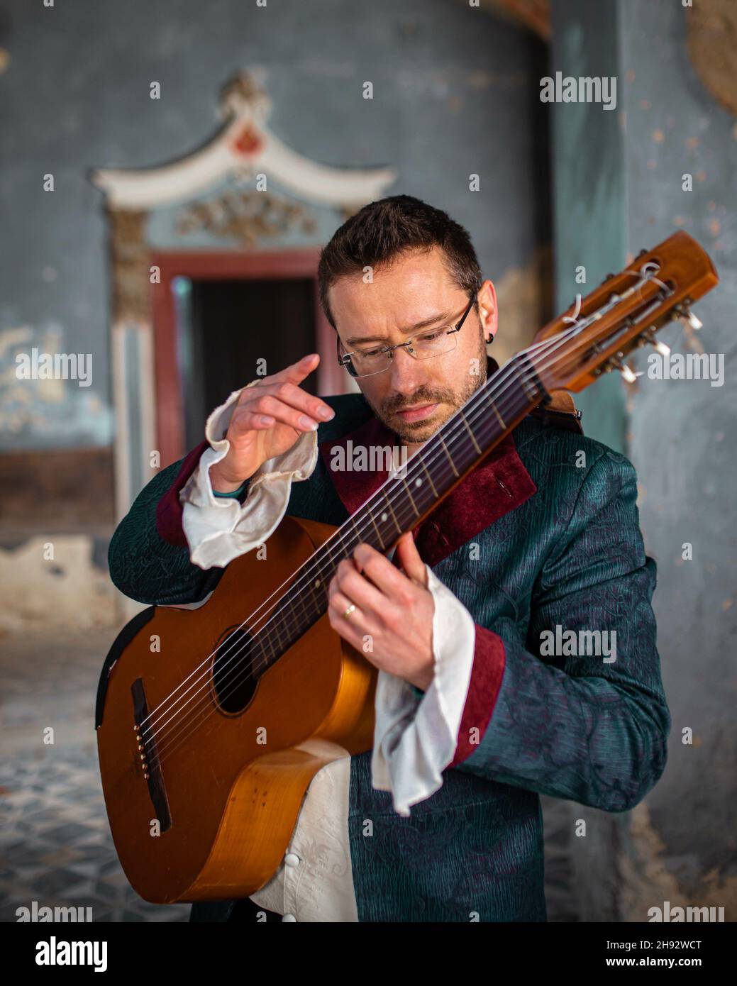Serbian man in glasses playing guitar Stock Photo - Alamy