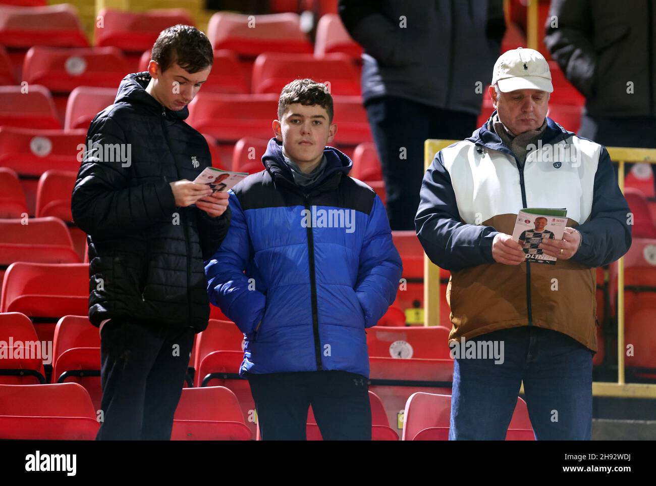 Fans look at the official match day programmes before the Emirates FA ...