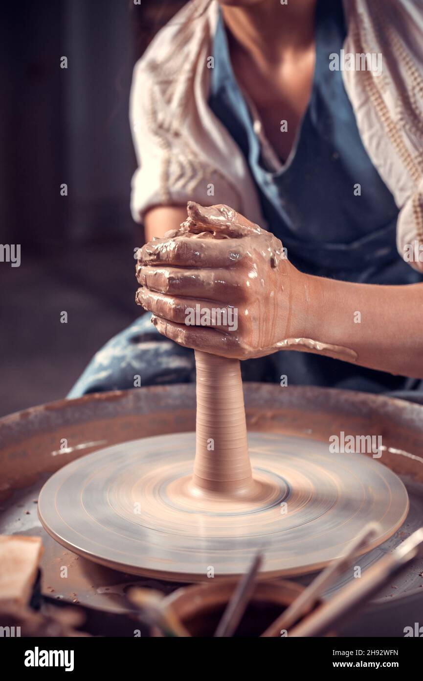 Artisan woman making ceramic pottery on wheel. National craft. Close-up ...