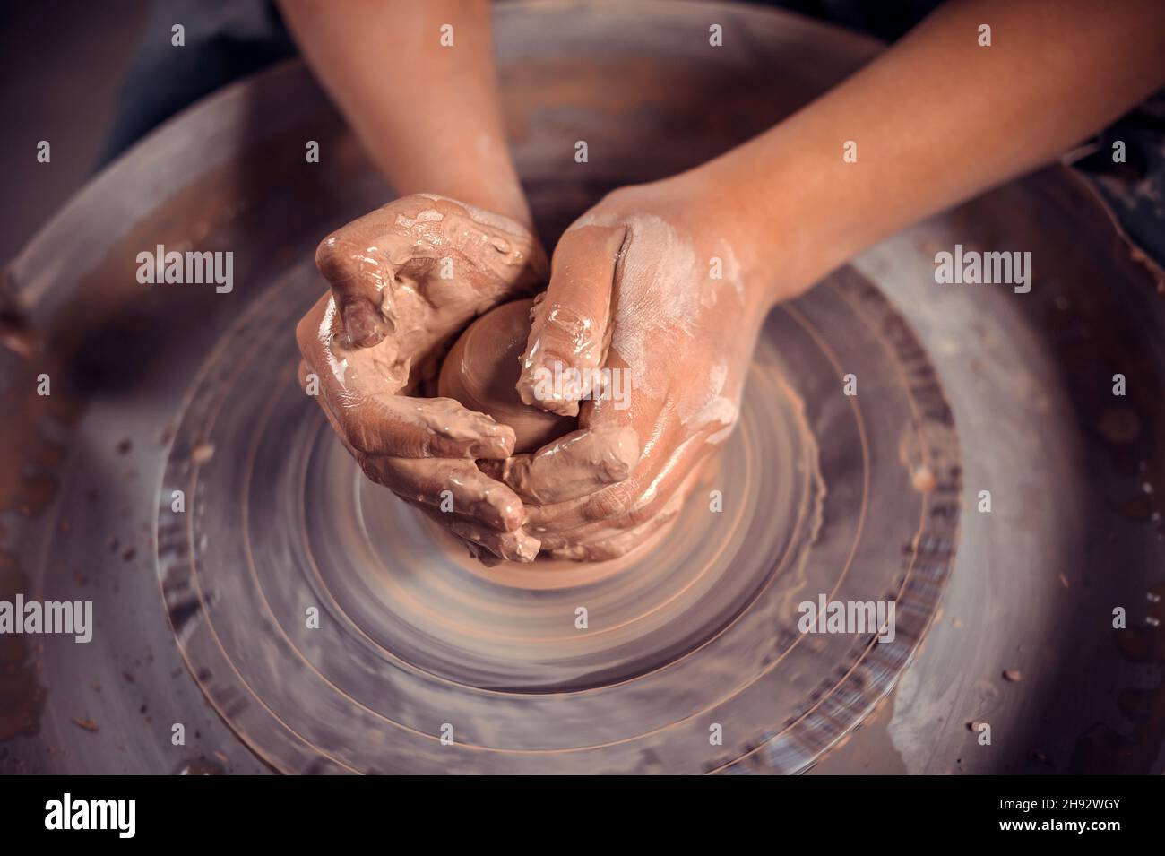 The potter's hands are shaped a cup from a clay. The process of ...