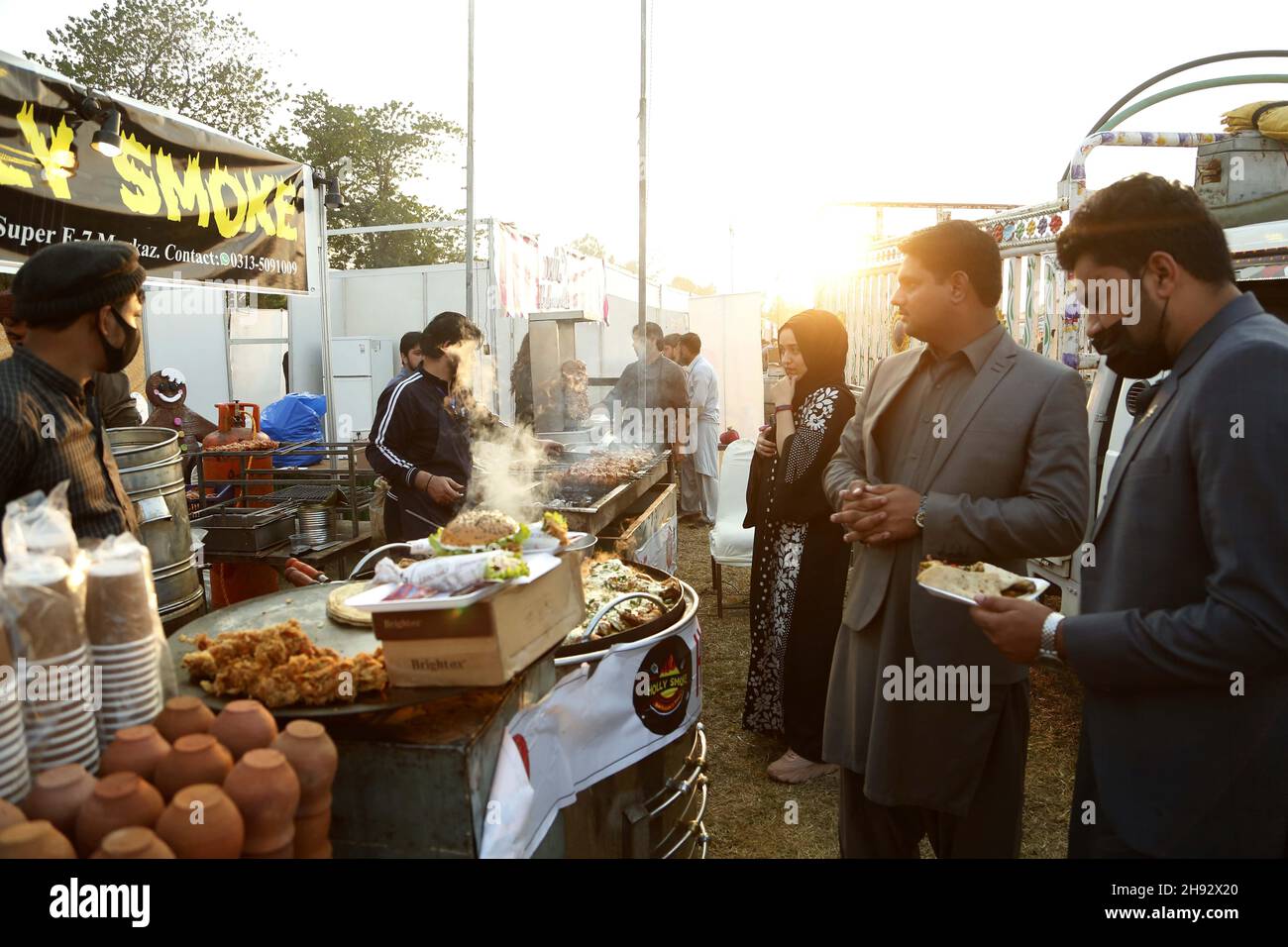 Islamabad, Pakistan. 3rd Dec, 2021. People visit a food stall during a ...