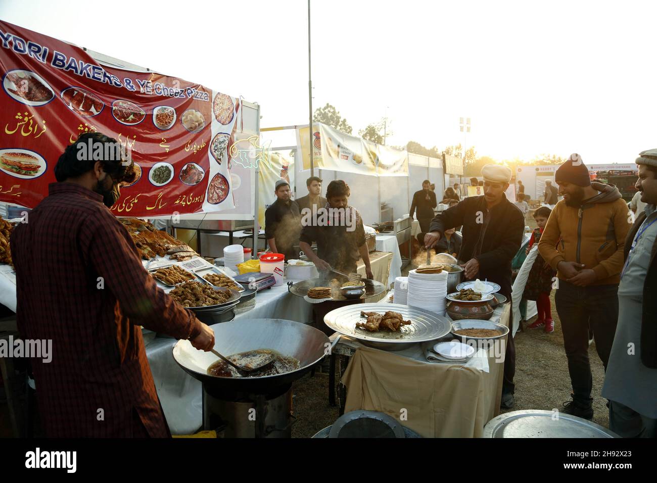 Islamabad, Pakistan. 3rd Dec, 2021. People visit a food stall during a ...