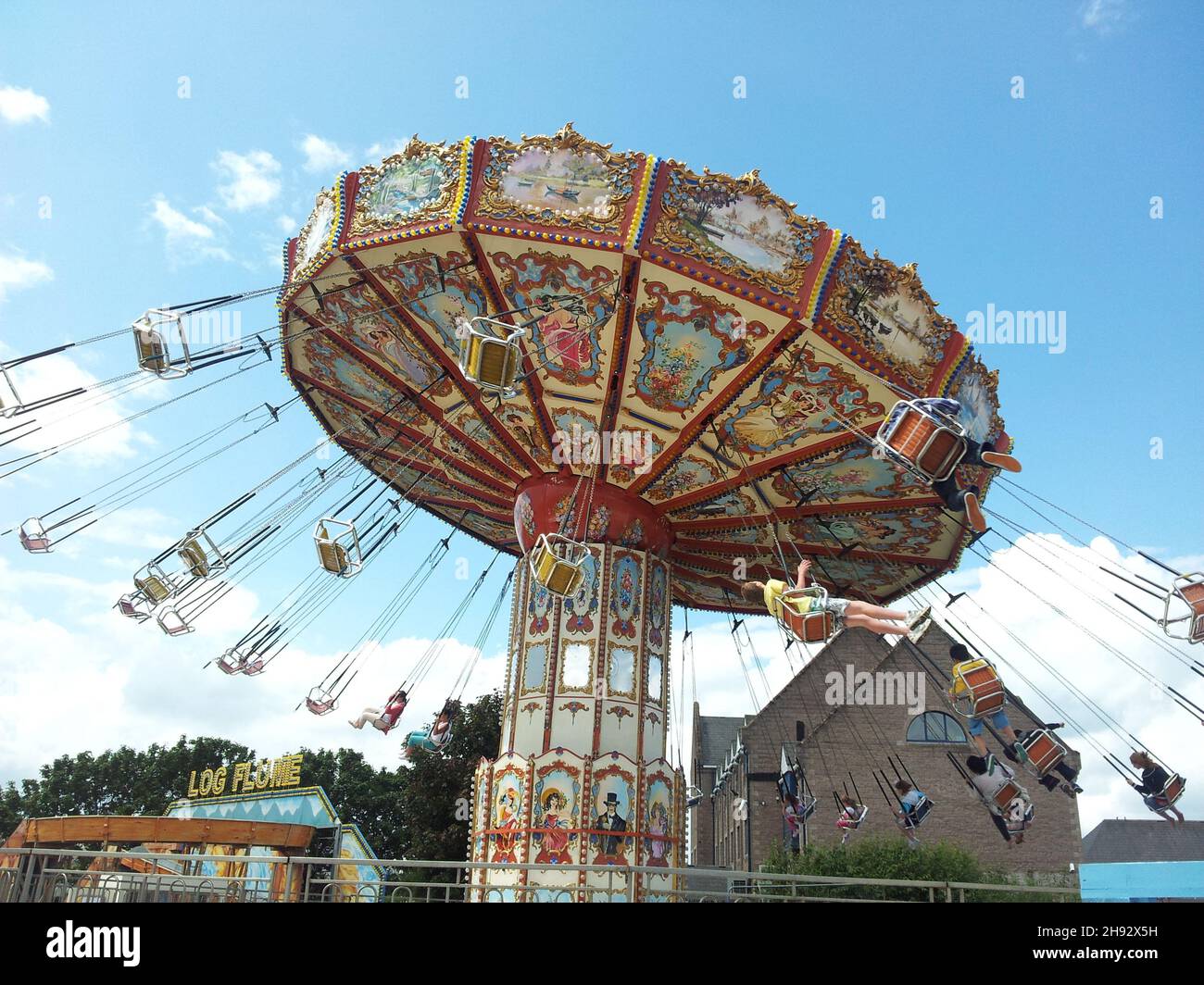 Chain carousel in a park against a cloudy sky Stock Photo - Alamy