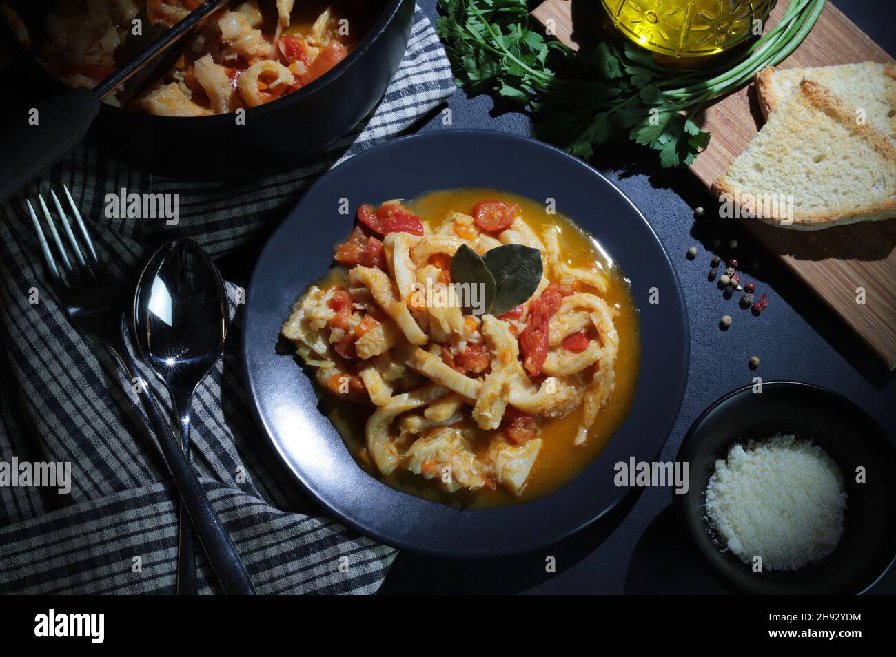 Italian food. Dish of typical beef tripe with tomato sauce with bread ...