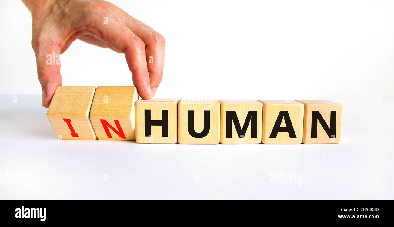 Human or inhuman symbol. Businessman turns wooden cubes and changes the ...