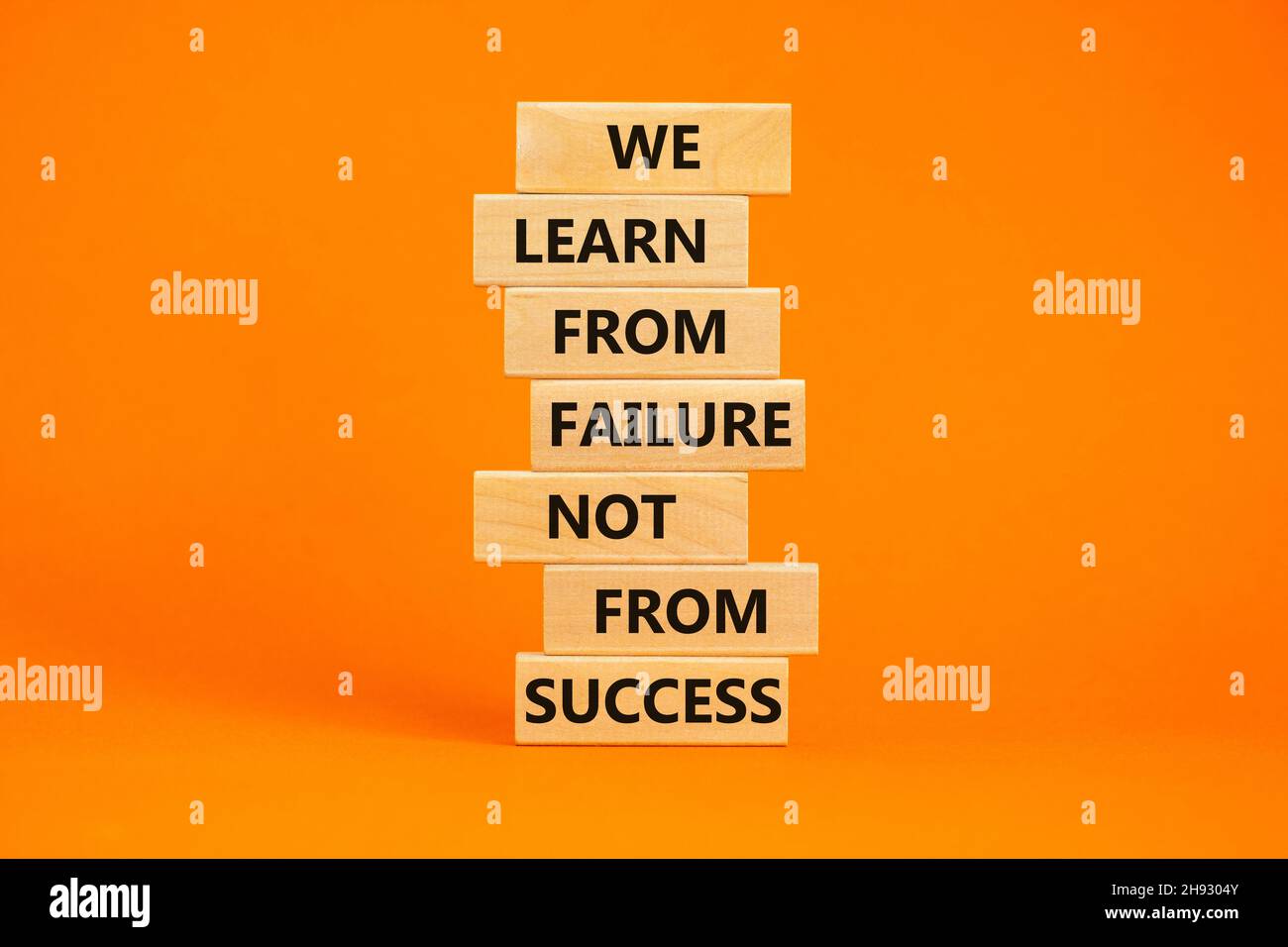 Failure or success symbol. Wooden blocks with words We learn from ...