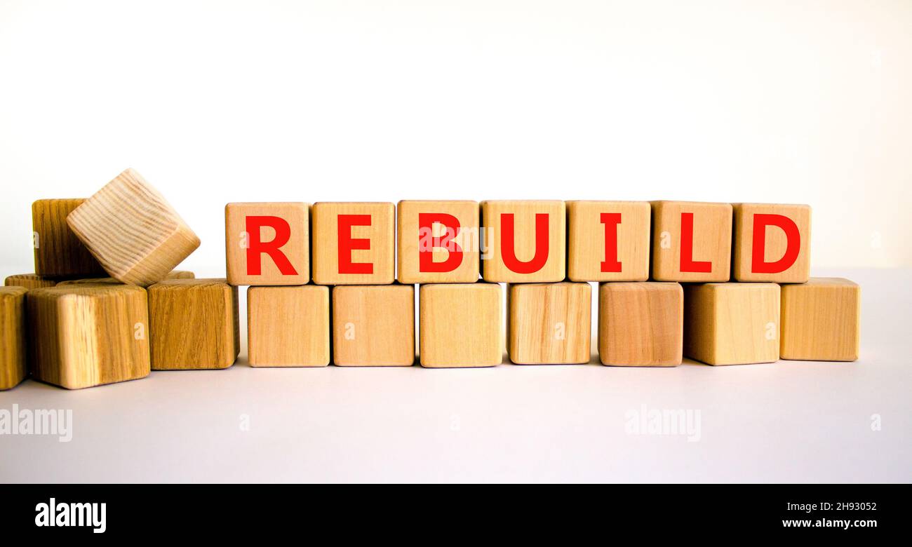 Rebuild and build symbol. The concept word Rebuild on wooden cubes ...
