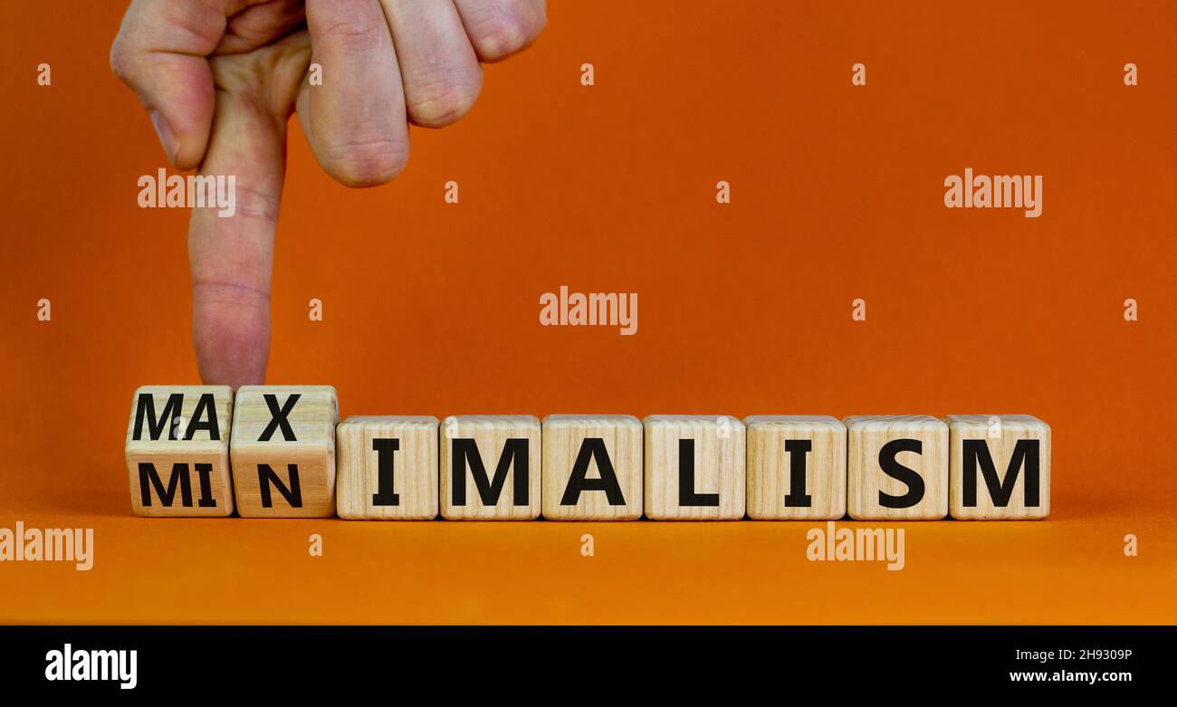 Minimalism or maximalism symbol. Businessman turns wooden cubes and ...