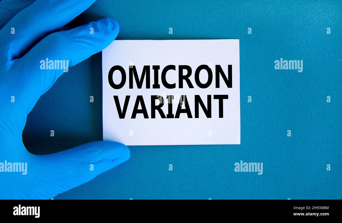 New covid-19 omicron variant strain symbol. Hand in blue glove with ...