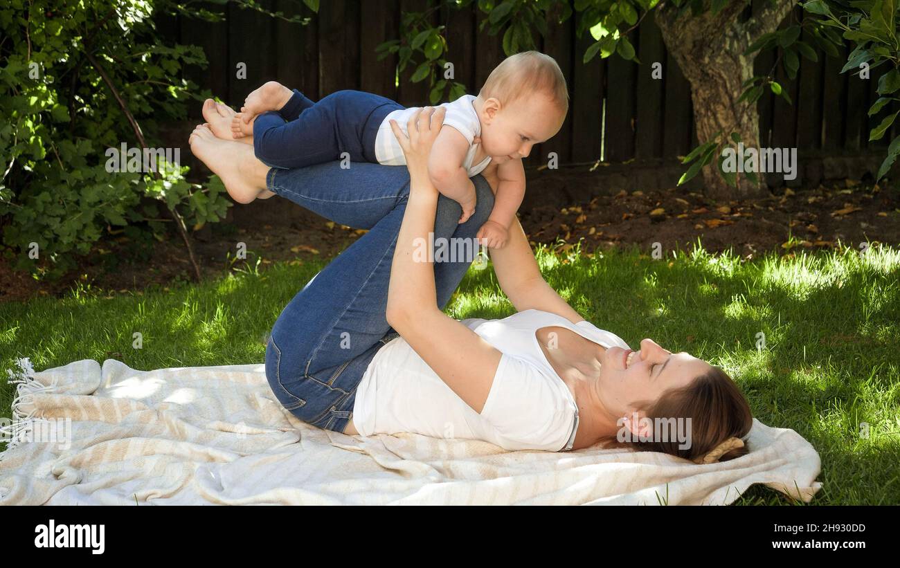 Mother lifting pretty baby in hi-res stock photography and images - Alamy