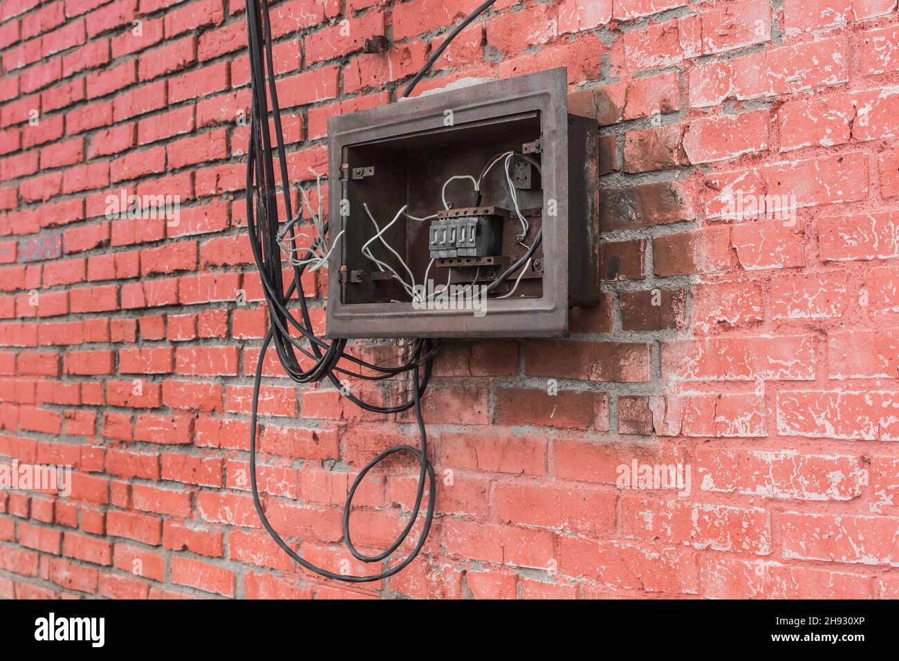 The niche of the old broken electrical panel of the drawer on the wall ...