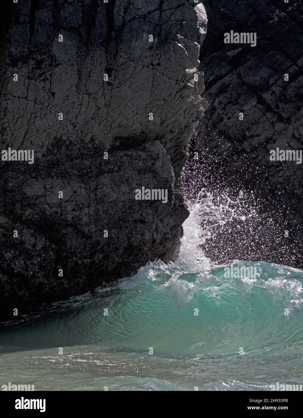 Incoming tide waves crashing against the rocks at Kynance Cove, on the ...