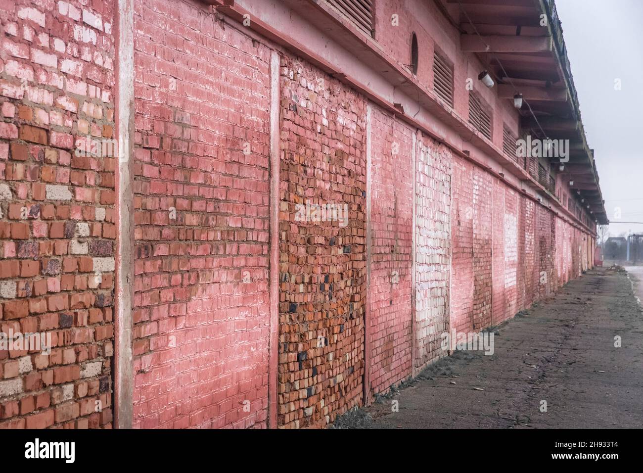 Old abandoned warehouse with a dirty worn brick wall weathered and ...