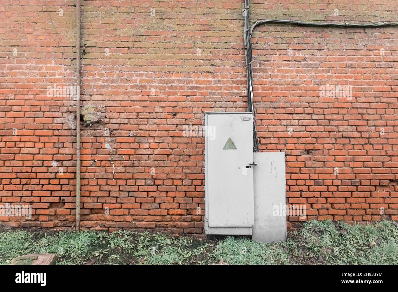 The old broken electrical panel or box on the wall. Industrial ...