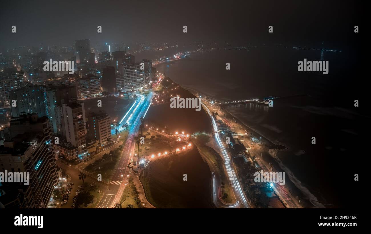 Aerial night view over the coastline of Miraflores District in Lima, the capital of Peru Stock ...