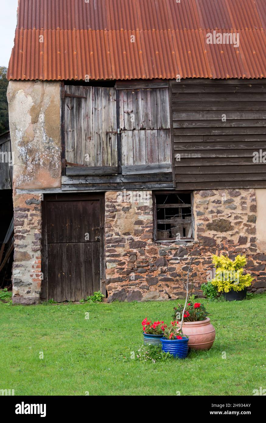 An old shed with a rusty corrugated steel roof. Old wooden panelled ...