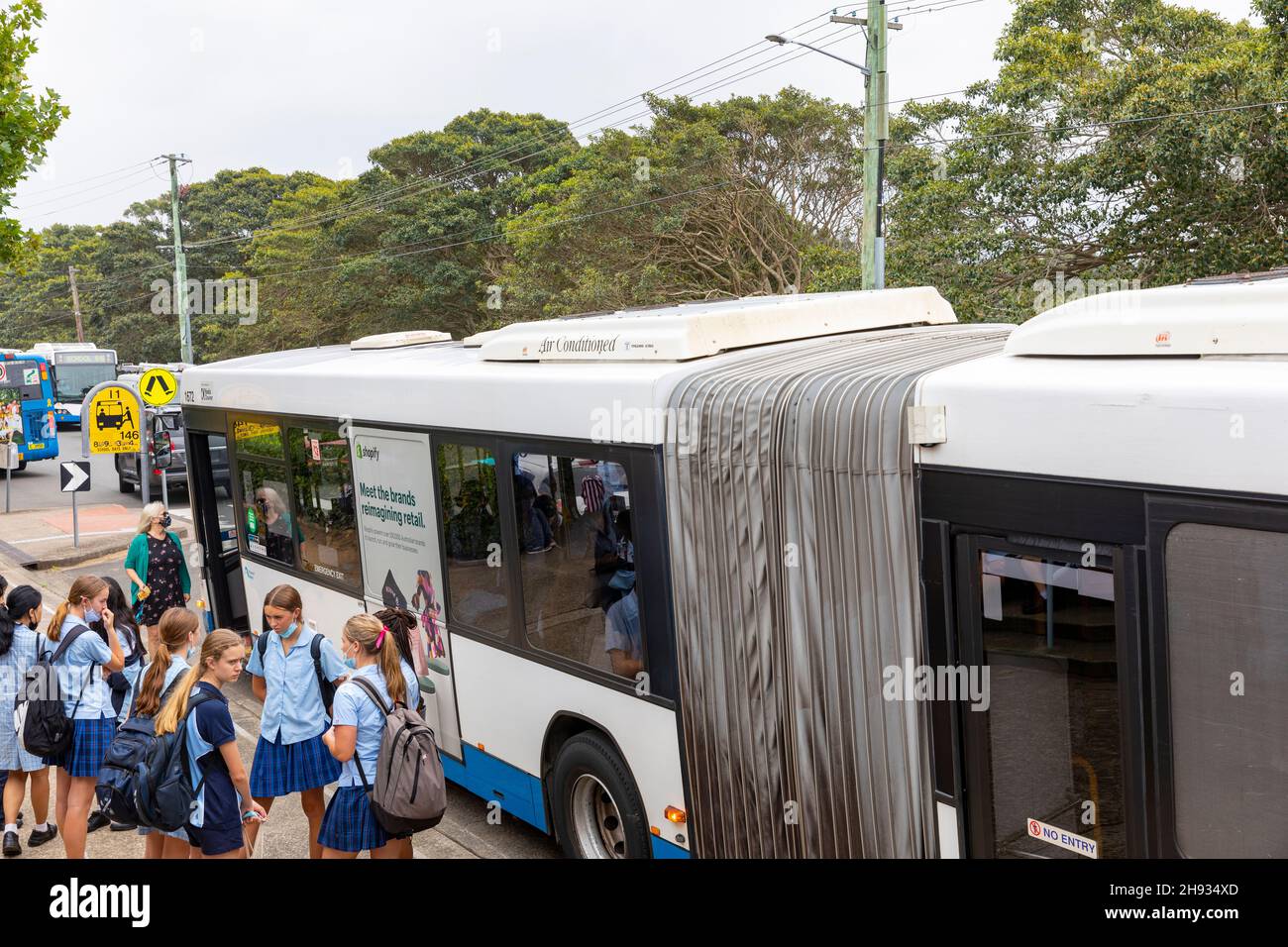 Girl students at a Sydney secondary school wait for their school bus at ...