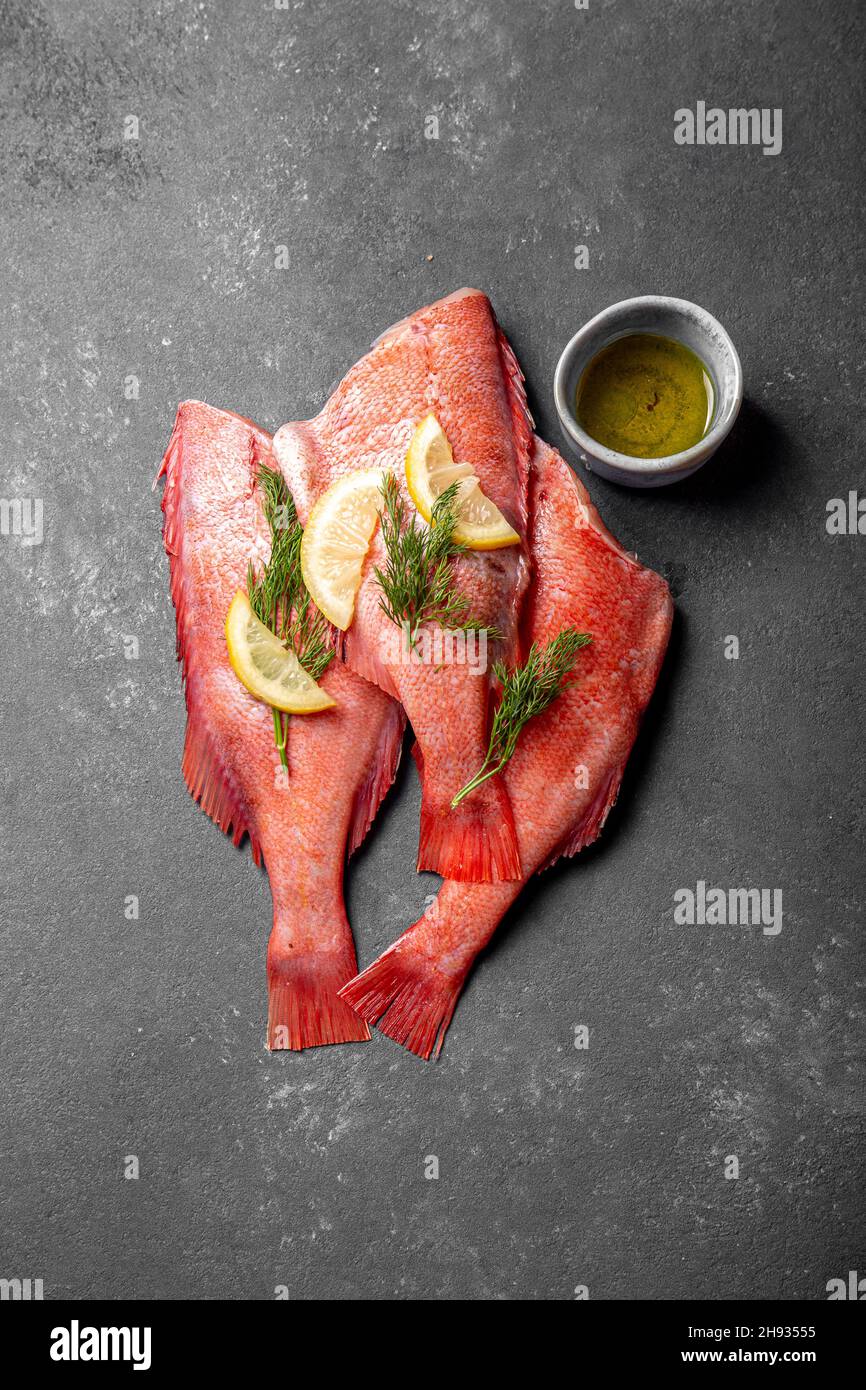 Fresh red sea bass on blue background Stock Photo - Alamy
