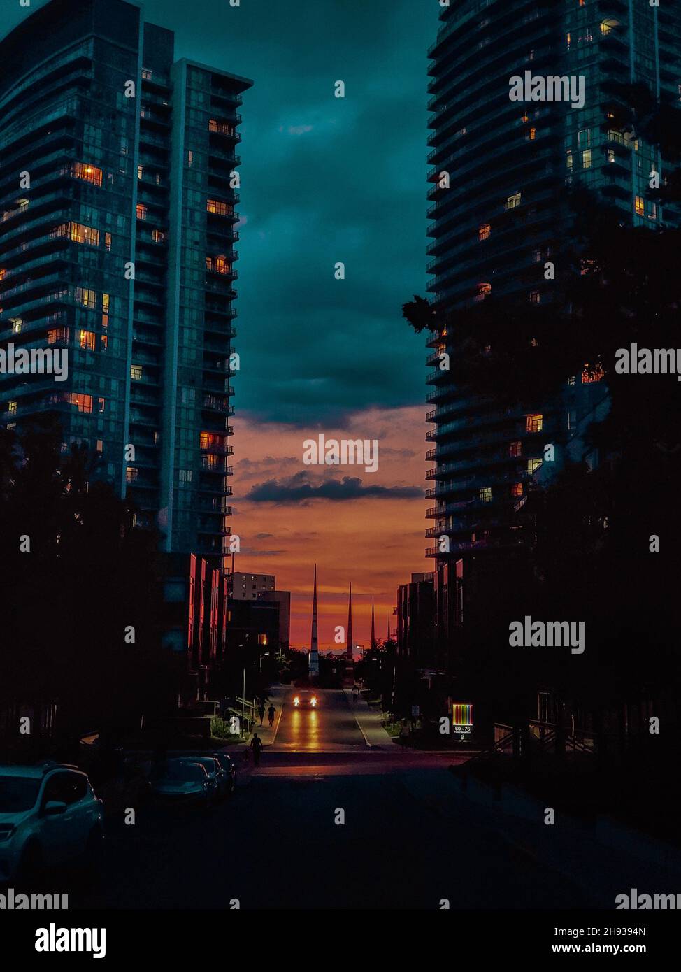 Beautiful orange sunset seen through high-rise buildings Stock Photo ...